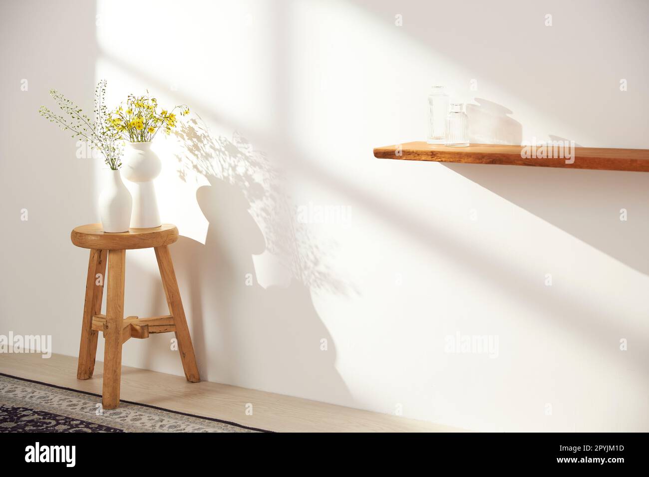 Vases and objects on the table in a warm room with sunlight coming in ...