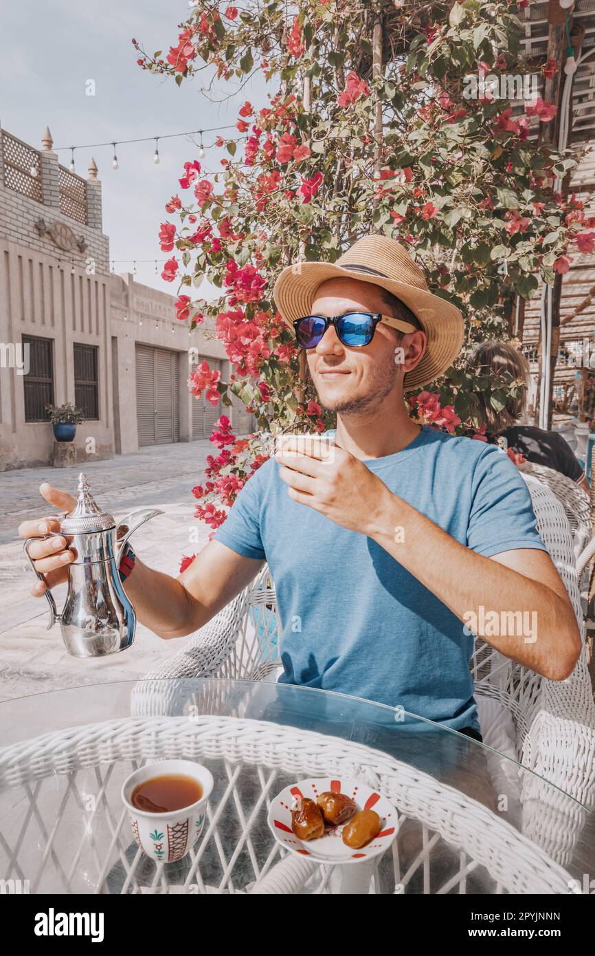 As he sits in a traditional cafe in the UAE, man sips on fragrant Arab ...