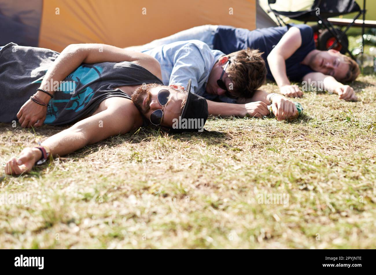 Drunk sleeping, hangover and party people on camping park at music ...