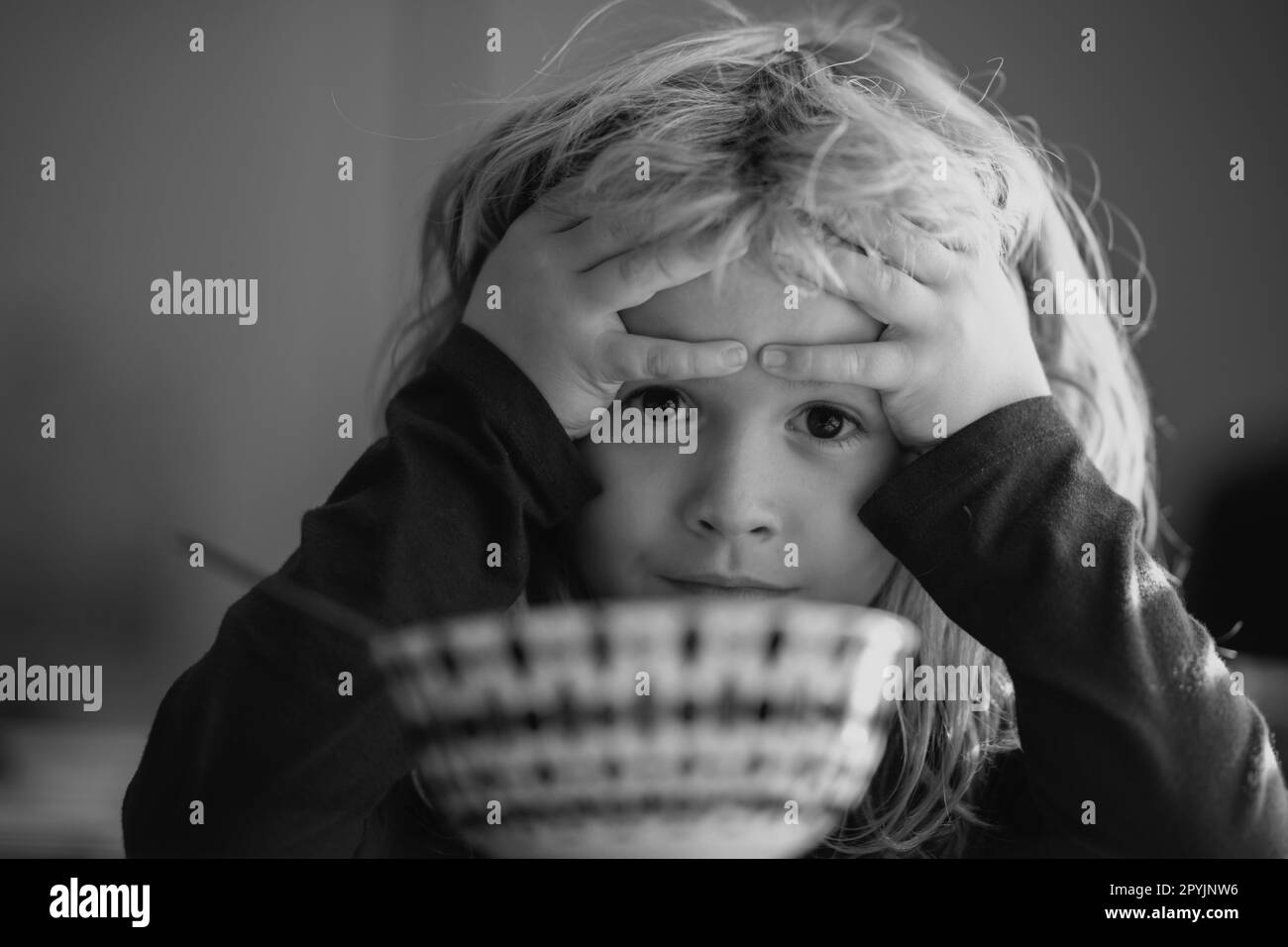 Child have a breakfast. Sad boy eating healthy chicken noodle soup for ...