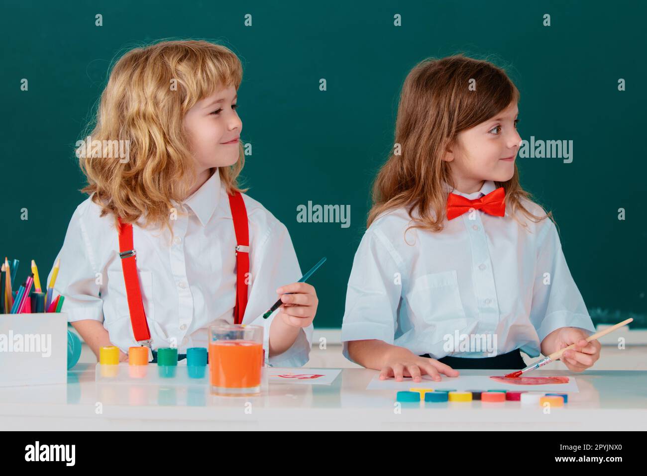 Cute school friends kids drawing and painting at school. Friendly boy ...