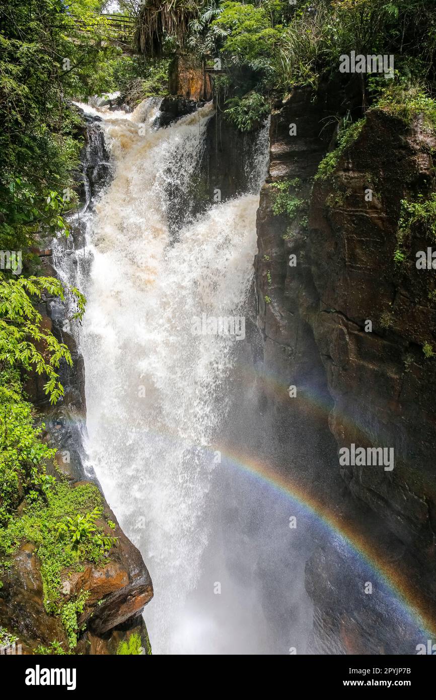 Close-up of splashing waterfall in a narrow ravine with rainbow Iguazu ...