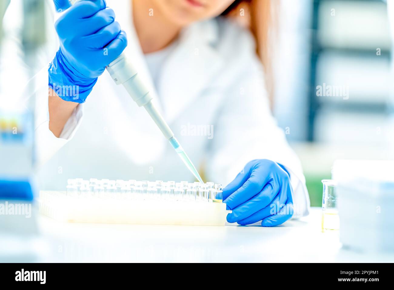 Scientist pipetting sample into test tube during experiment lab hi-res ...