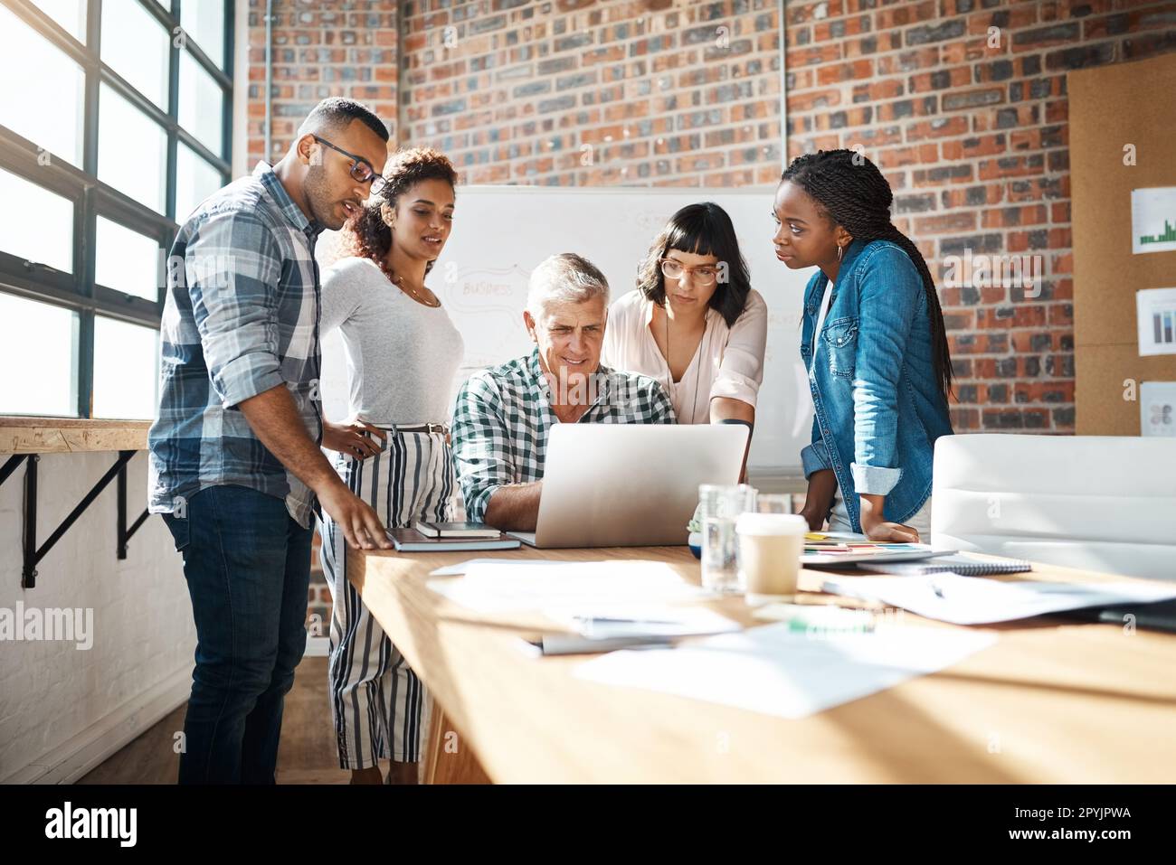 Growing businesses thrive on teamwork. a group of colleagues using a ...