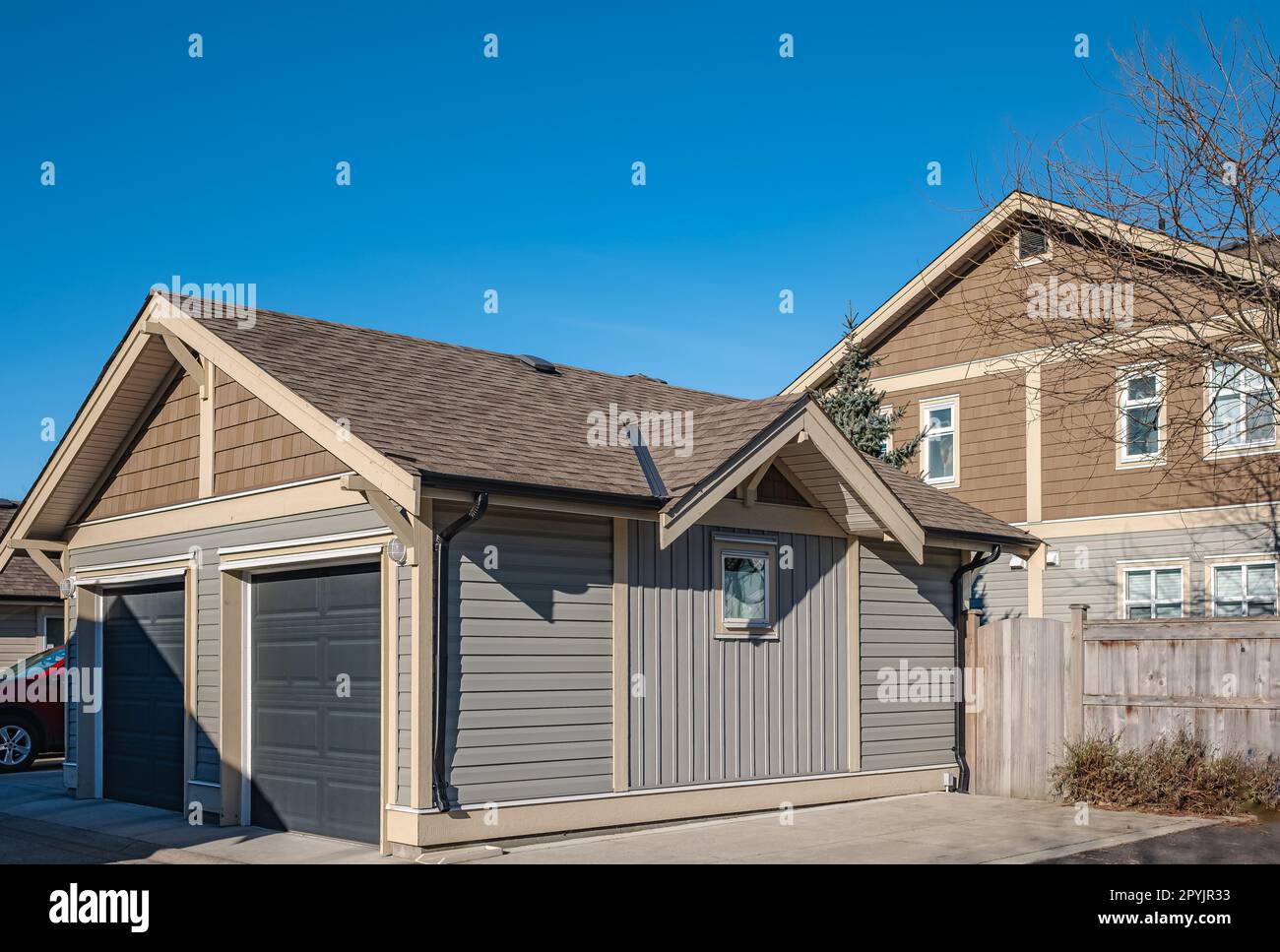 Big house with garage and backyard, exterior view. Wide garage double ...