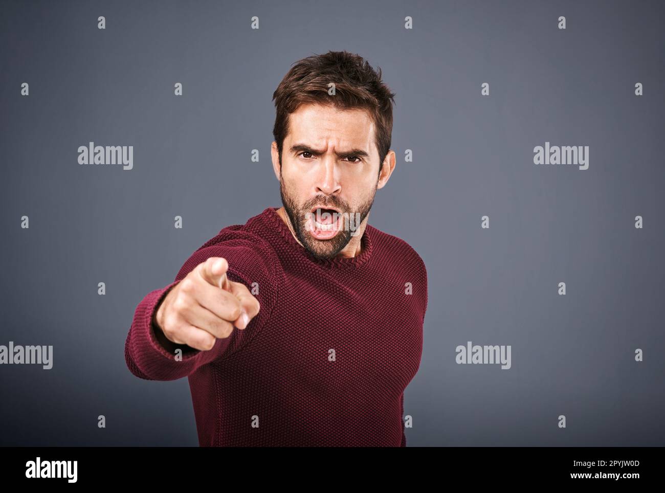 Who do you think you are. Studio shot of a handsome young man pointing ...