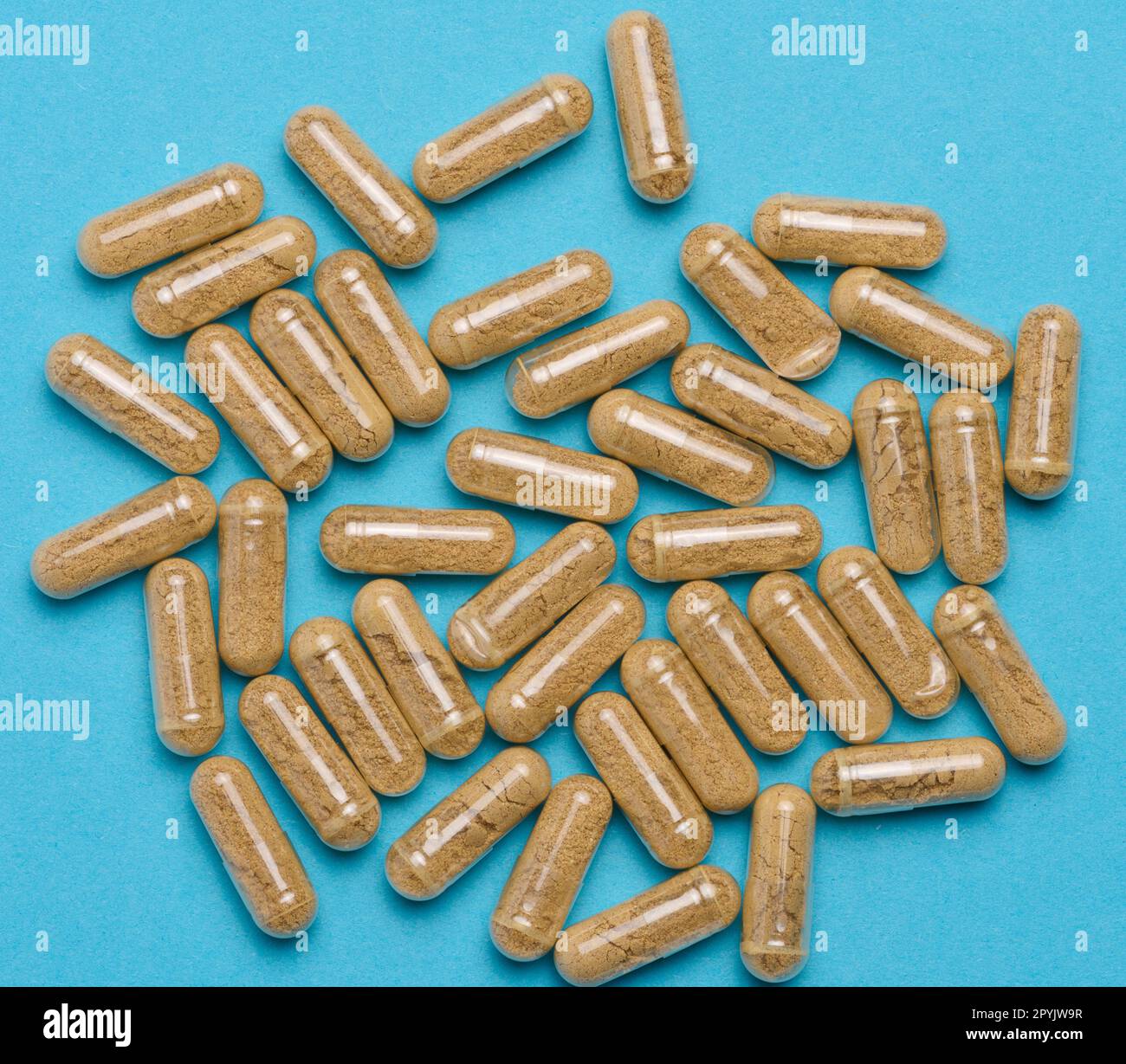 Transparent capsule on blue background Stock Photo - Alamy