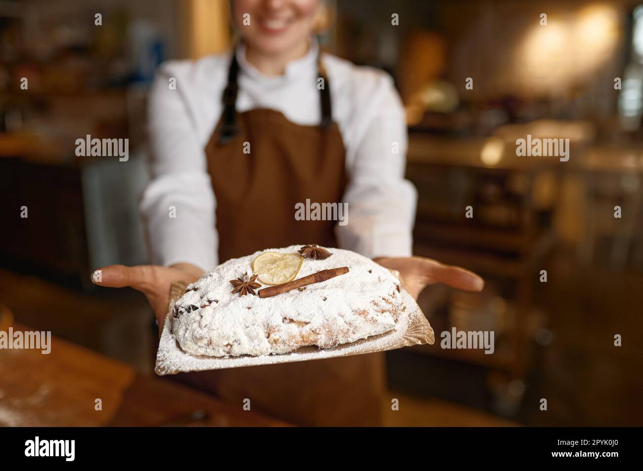 Young woman baker wearing uniform showing fresh bread closeup Stock ...