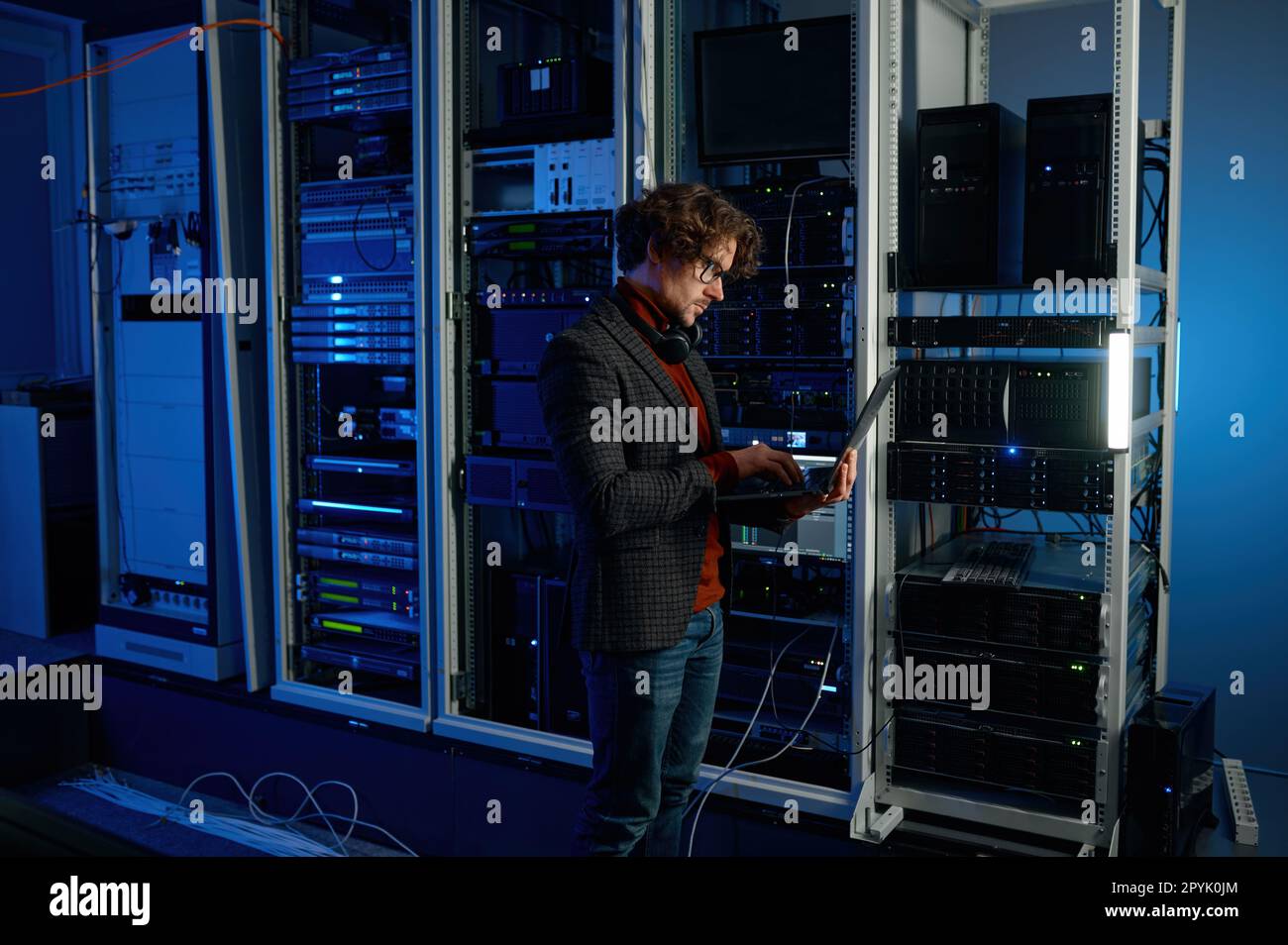 IT technician using digital tablet while working in data center with server rack Stock Photo - Alamy