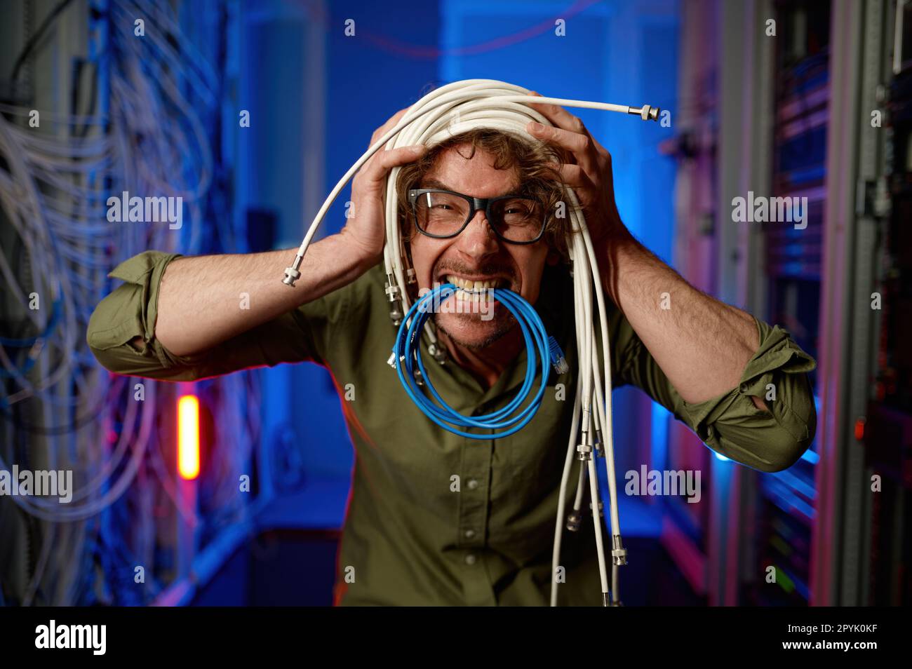 Funny crazy system administrator with head wrapped in wires fooling ...