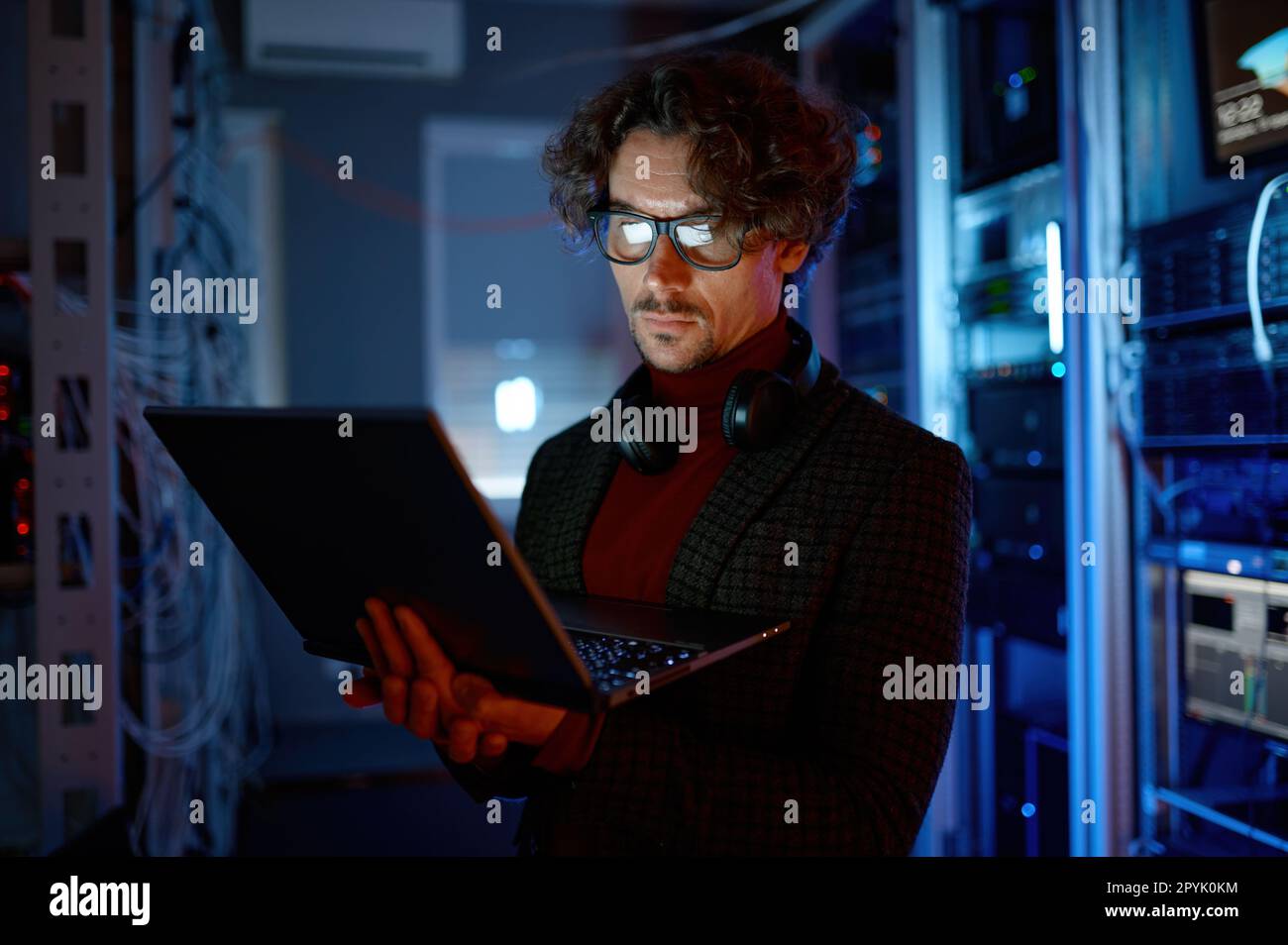 IT technician checking the servers vitals using laptop computer Stock ...