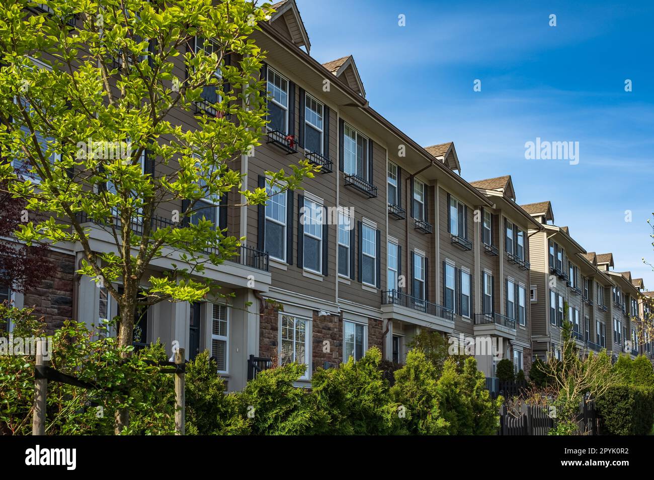 Facade of new residential townhouses. Modern apartment buildings in ...