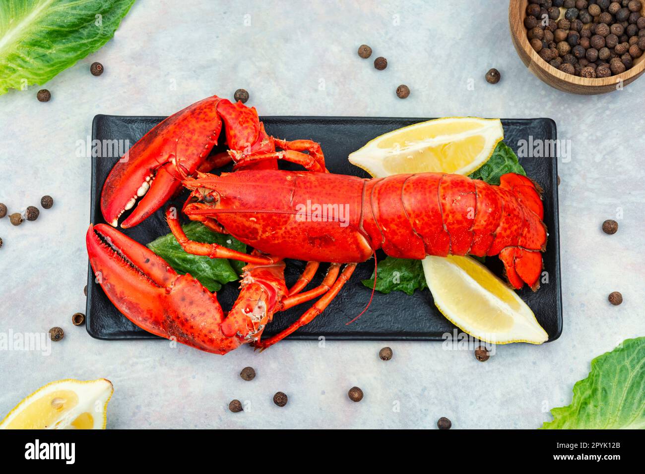 Whole red lobster with fresh herbs Stock Photo - Alamy