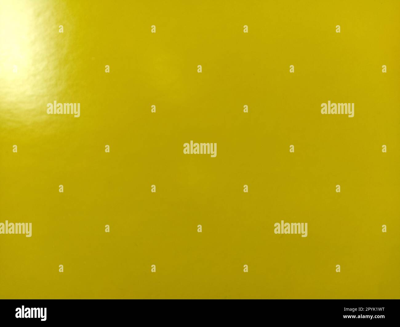 Beautiful bright yellow background. Close-up sheet of shiny reflective ...