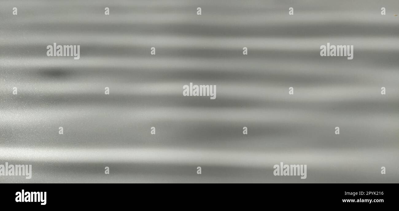 blurred horizontally striped gray background. Play of light and shadow ...