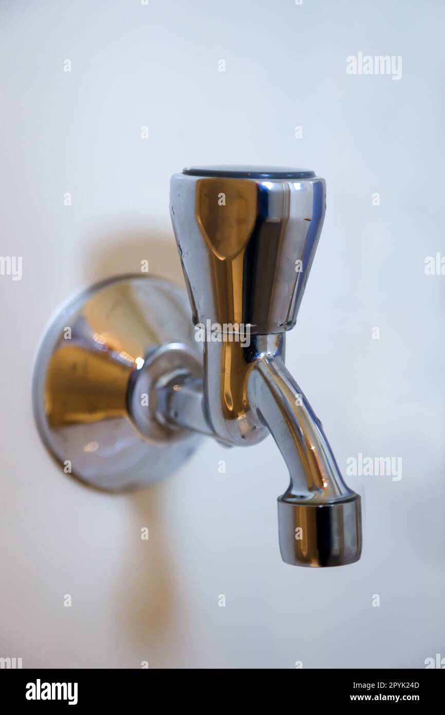 Close-up of a water tap on a white wall Stock Photo - Alamy