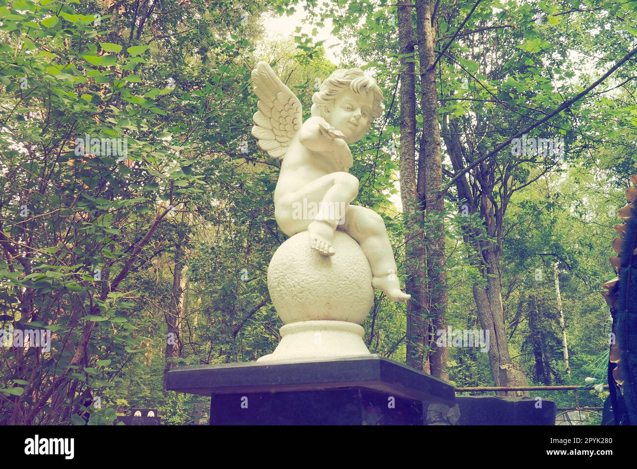 Angel in the cemetery monument at the grave of a child sculpture in the ...