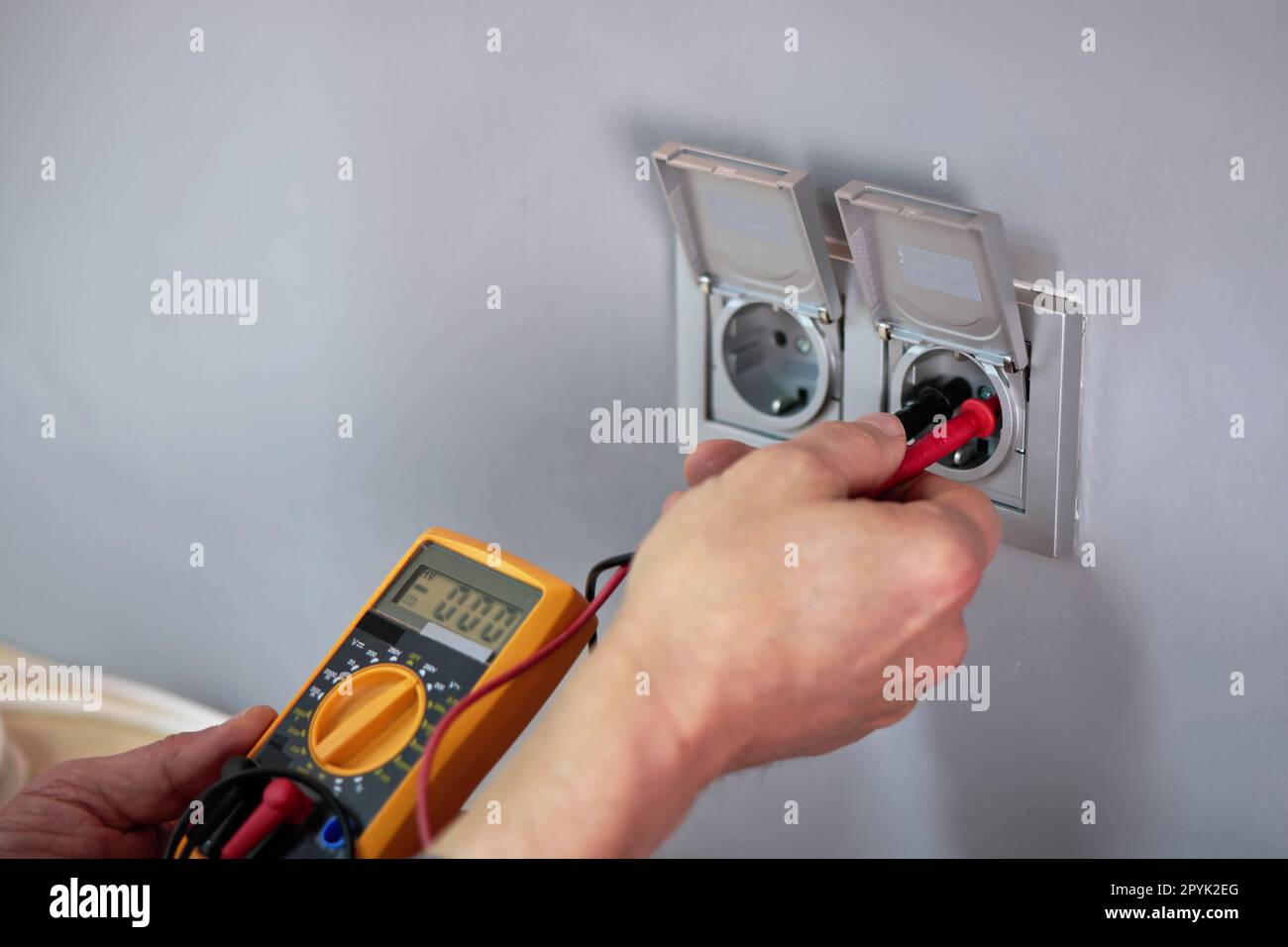 Male Electrician Checking Voltage Of Socket With Multimeter Stock Photo ...
