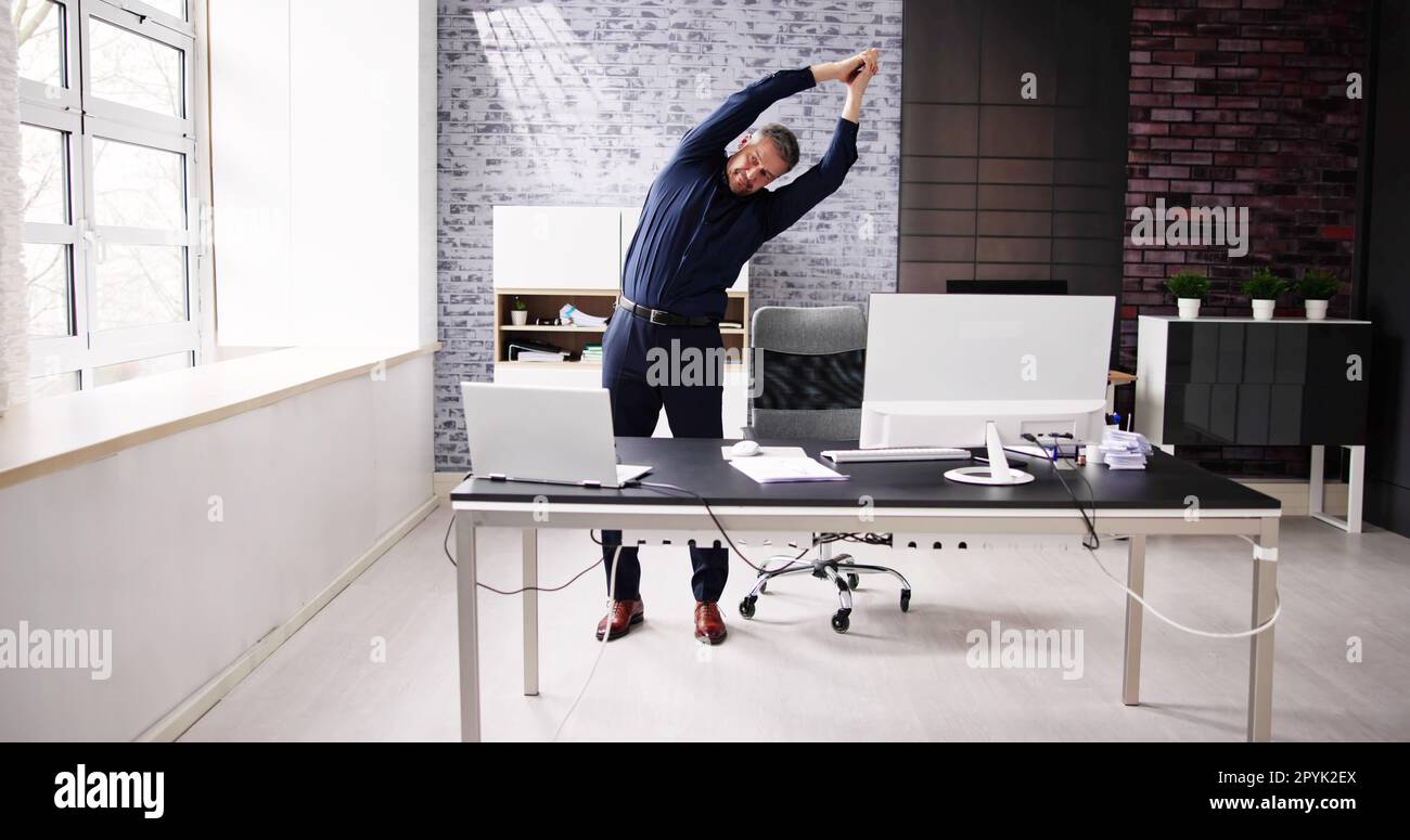 Arms Stretch Exercise Standing Near Desk Stock Photo - Alamy