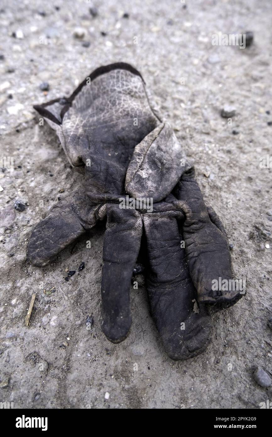 Dirty glove thrown away Stock Photo - Alamy