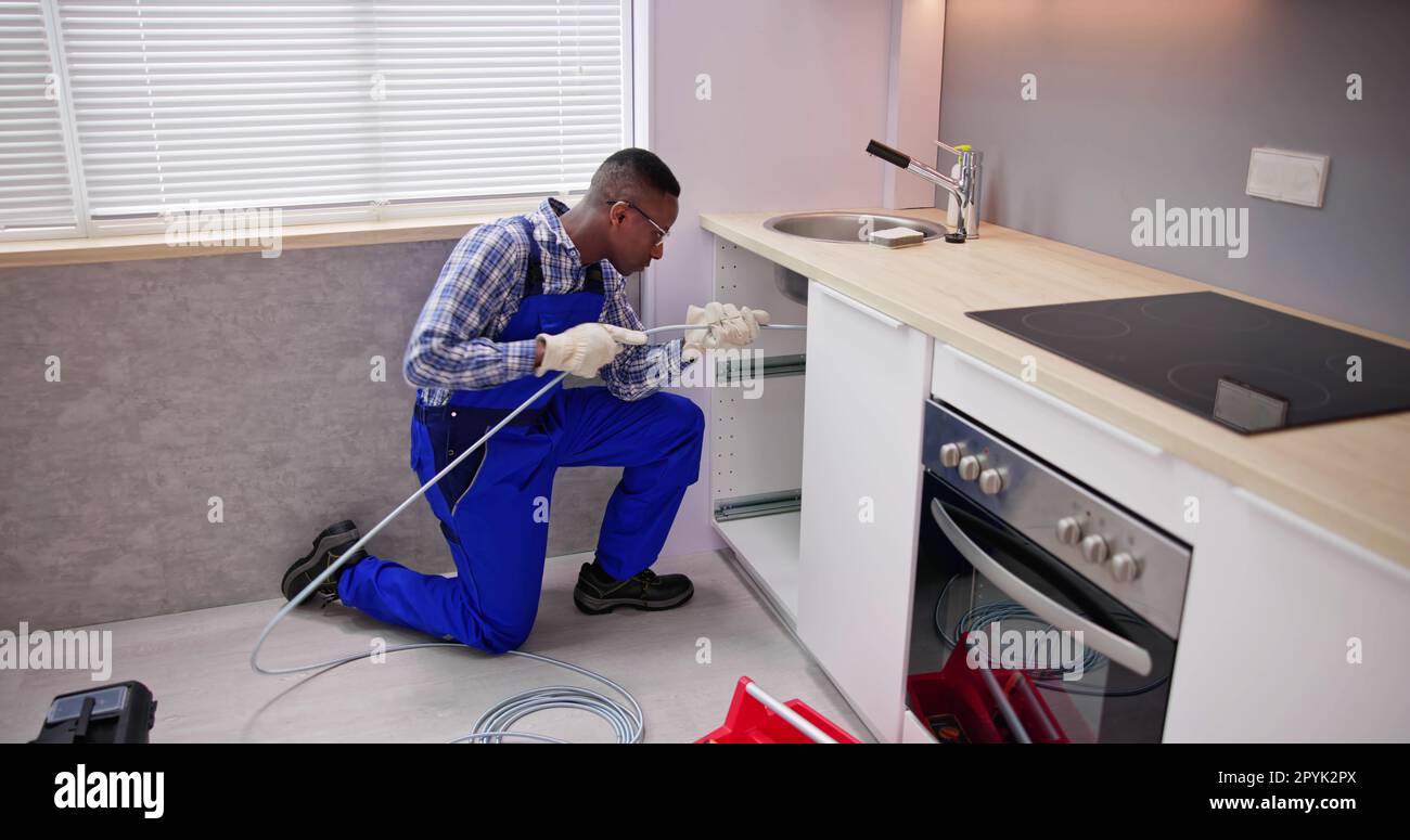 Young Male Plumber Cleaning Clogged Sink Pipe Stock Photo - Alamy Young Male Plumber Cleaning Clogged Sink Pipe Stock Photo - Alamy
