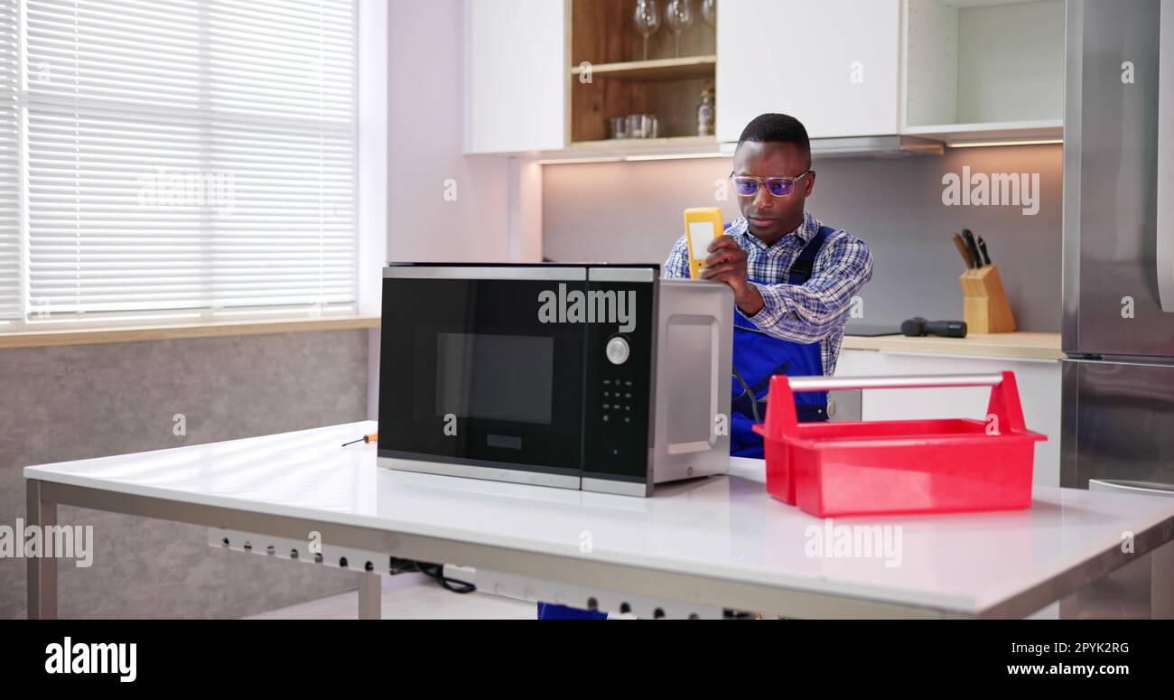 Repair Microwave Fix Appliance Technician Domestic Stock Photo - Alamy
