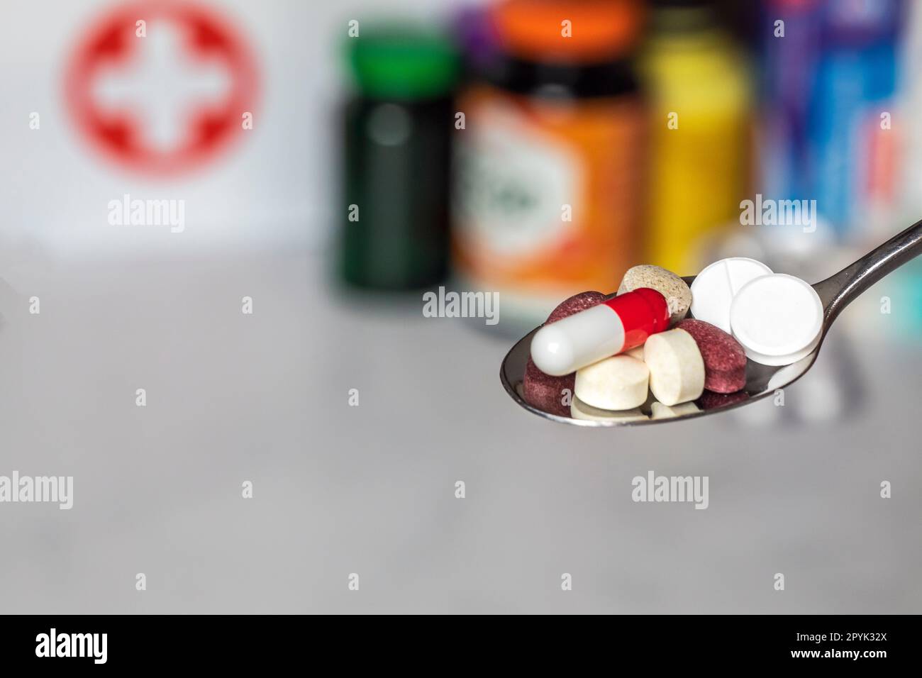 Assorted pharmaceutical medicine pills, tablets and capsules on spoon ...