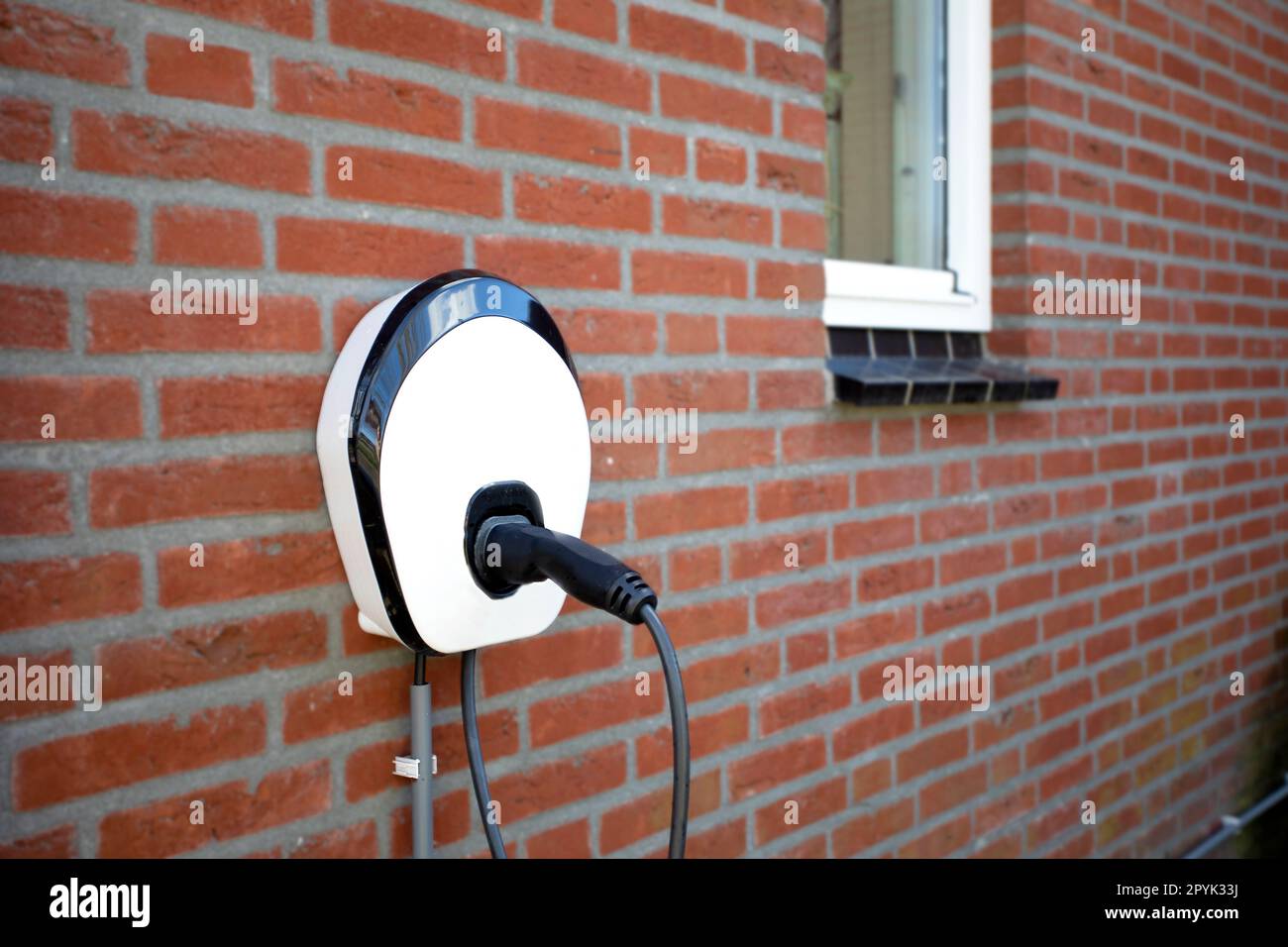 Power cable pump plug in charging power to electric vehicle EV car with ...