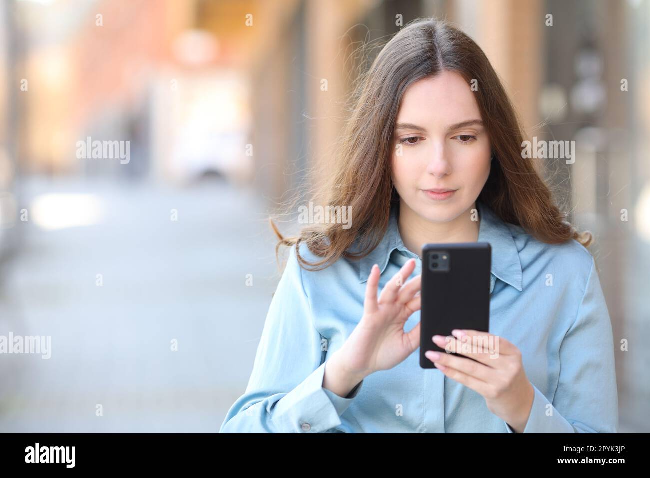 Person walking street looking watch hi-res stock photography and images ...