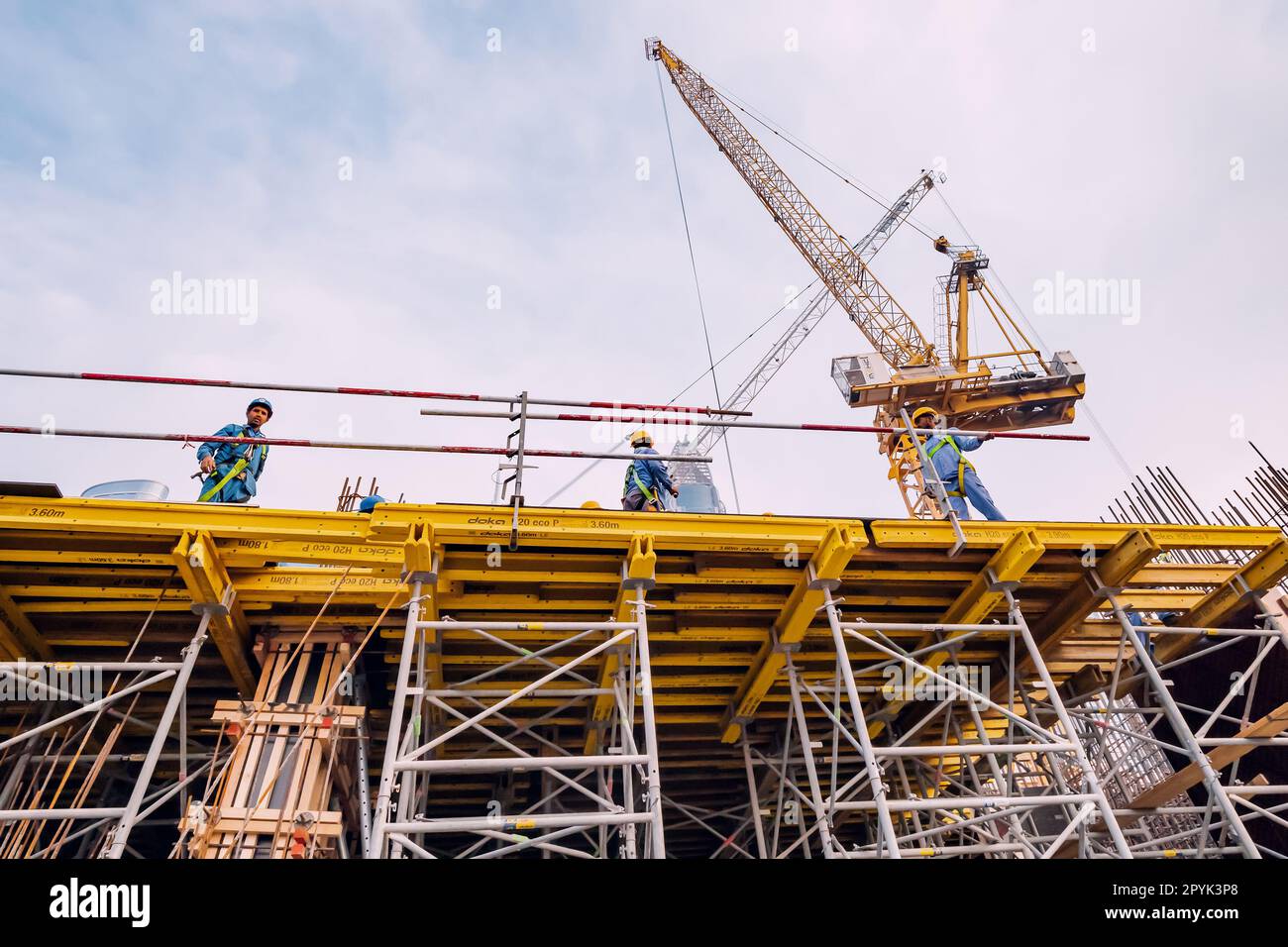 17 January 2023, Dubai, UAE: Workers in helmets on a construction site ...