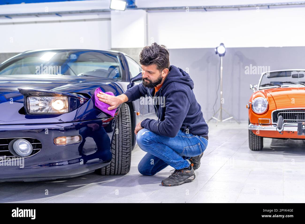 detailing and polishing the body of a luxury sports car using a micro ...