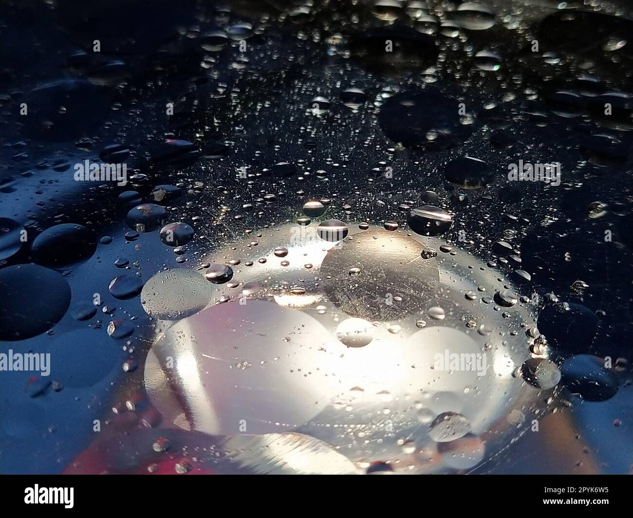 Round drops of different sizes. Drops of oil in water with color ...