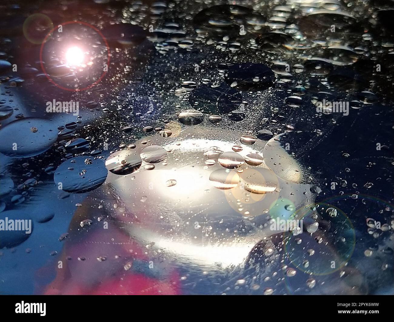 Round drops of different sizes. Drops of oil in water with color ...