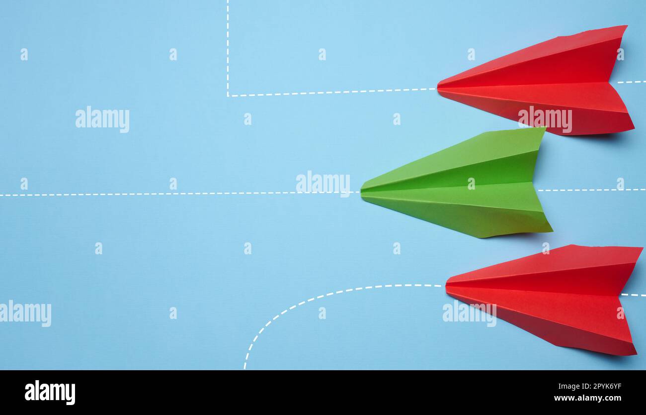 Three paper airplanes are moving forward, one turned sideways ...