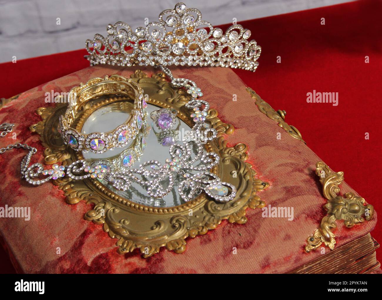 Crystal Rhinestone Jewelry and Tiara on Antique Book Stock Photo - Alamy