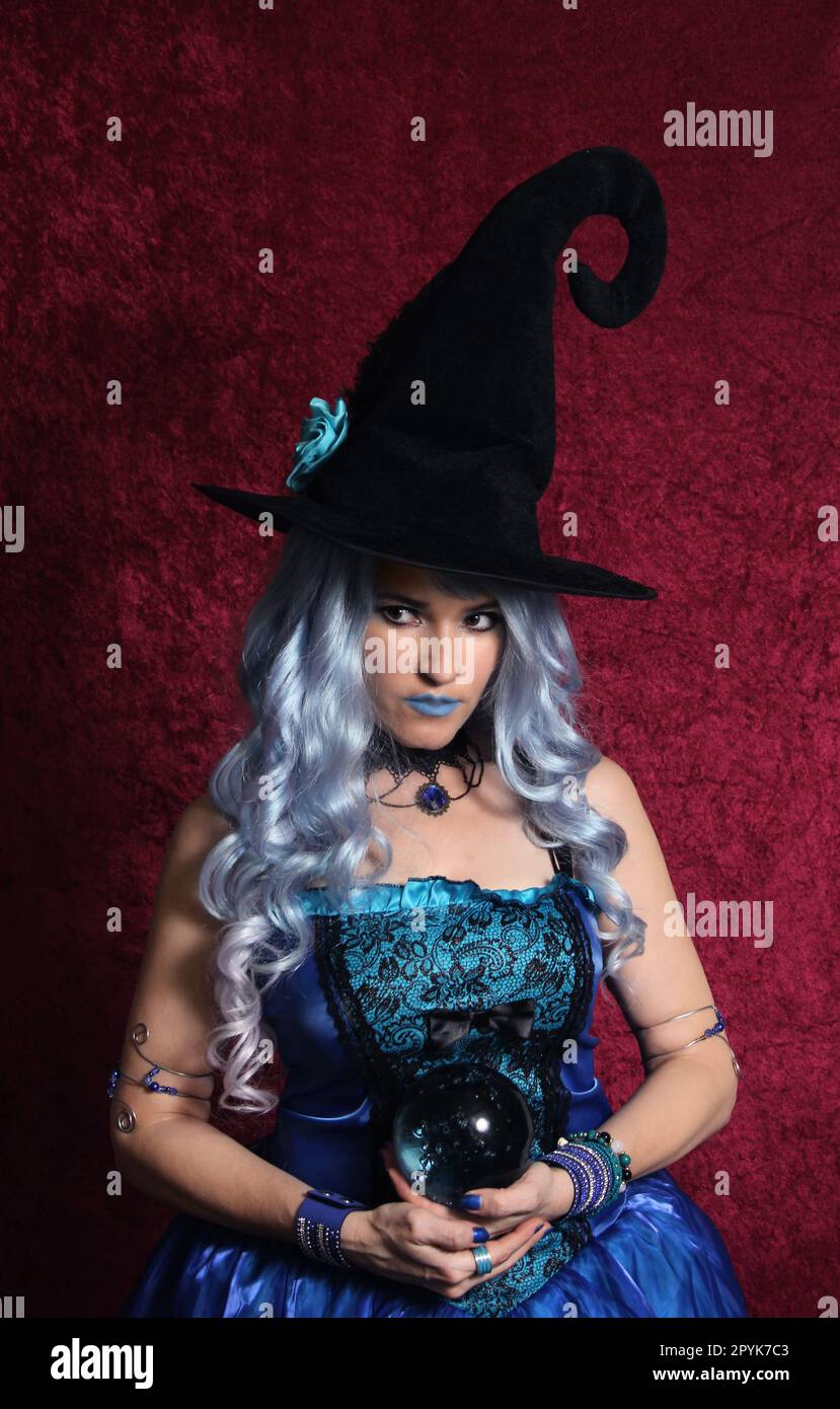 Woman Dressed as Blue Witch Holding Crystal Ball Stock Photo - Alamy