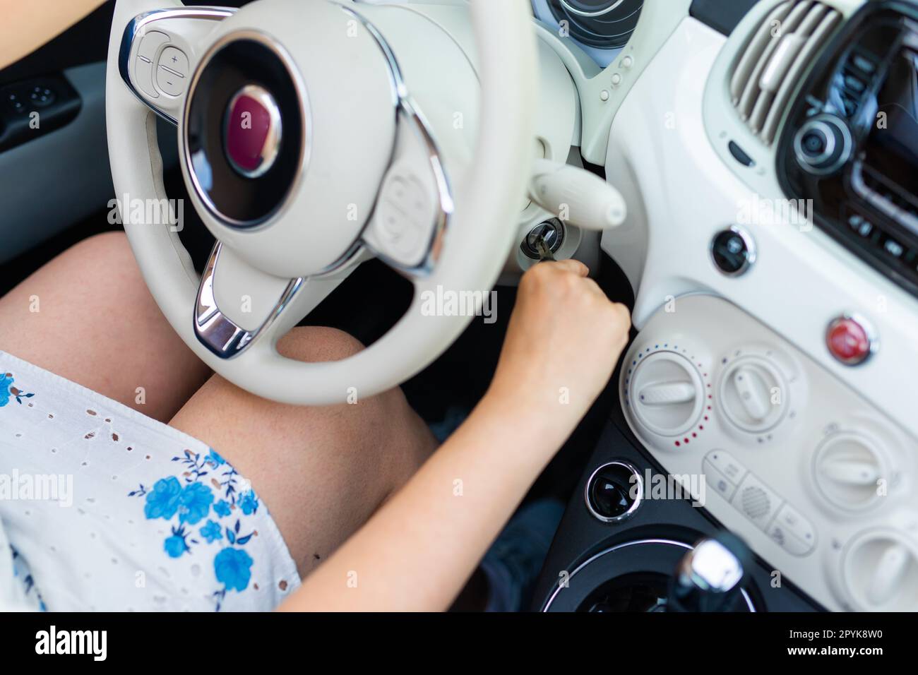 Female driver hand inserting car key and starting engine close up Stock ...