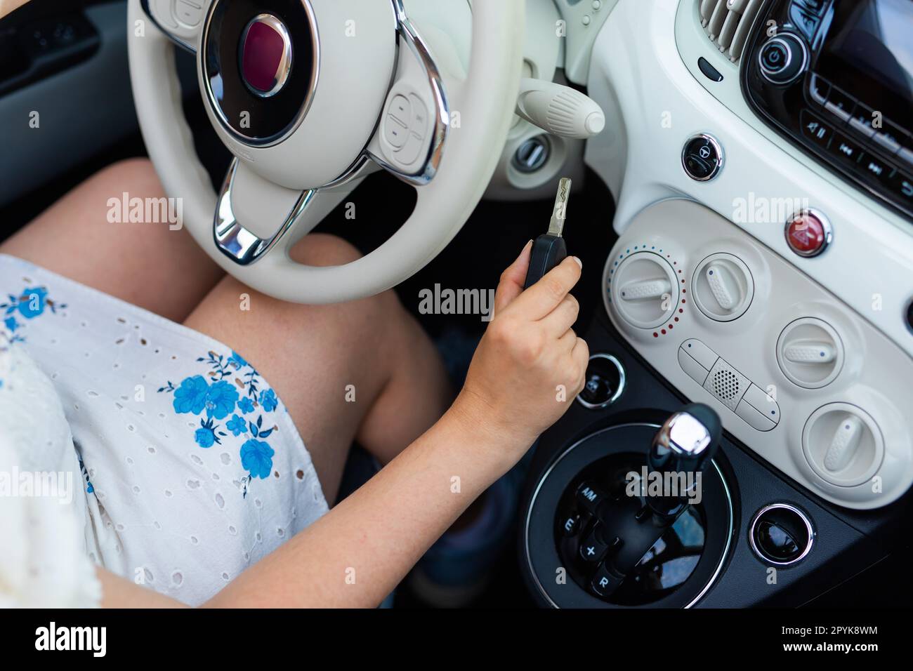 Hand putting car key to the keyhole starting car Stock Photo - Alamy