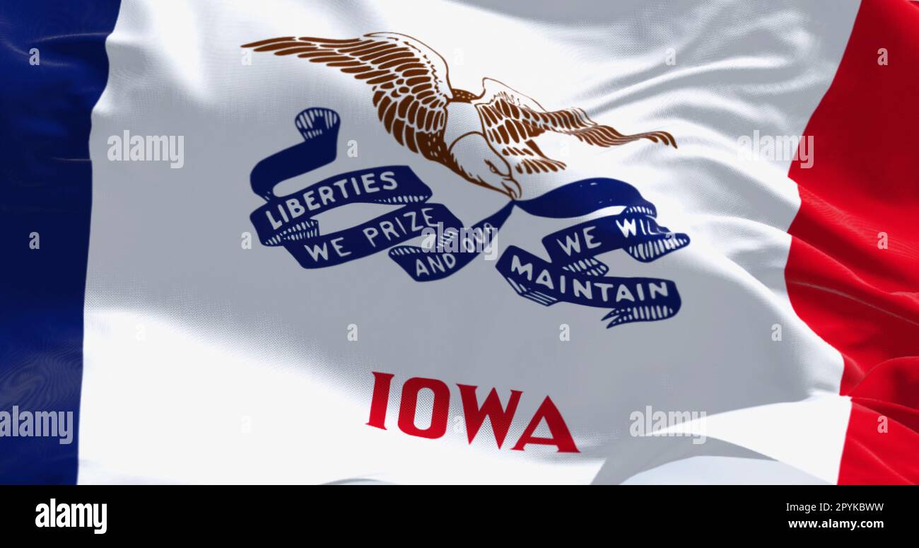 Close-up of the Iowa state flag waving. Three vertical stripes of blue ...