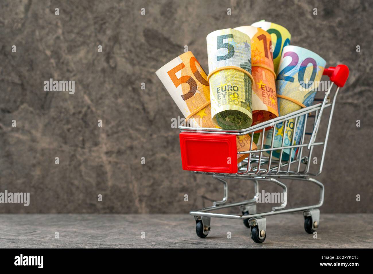 Economic concept. Shopping cart with euro banknotes Stock Photo - Alamy
