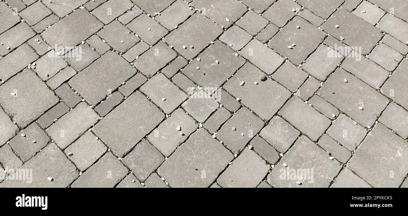 Cobbled street of the old city, lined with square and rectangular stone ...