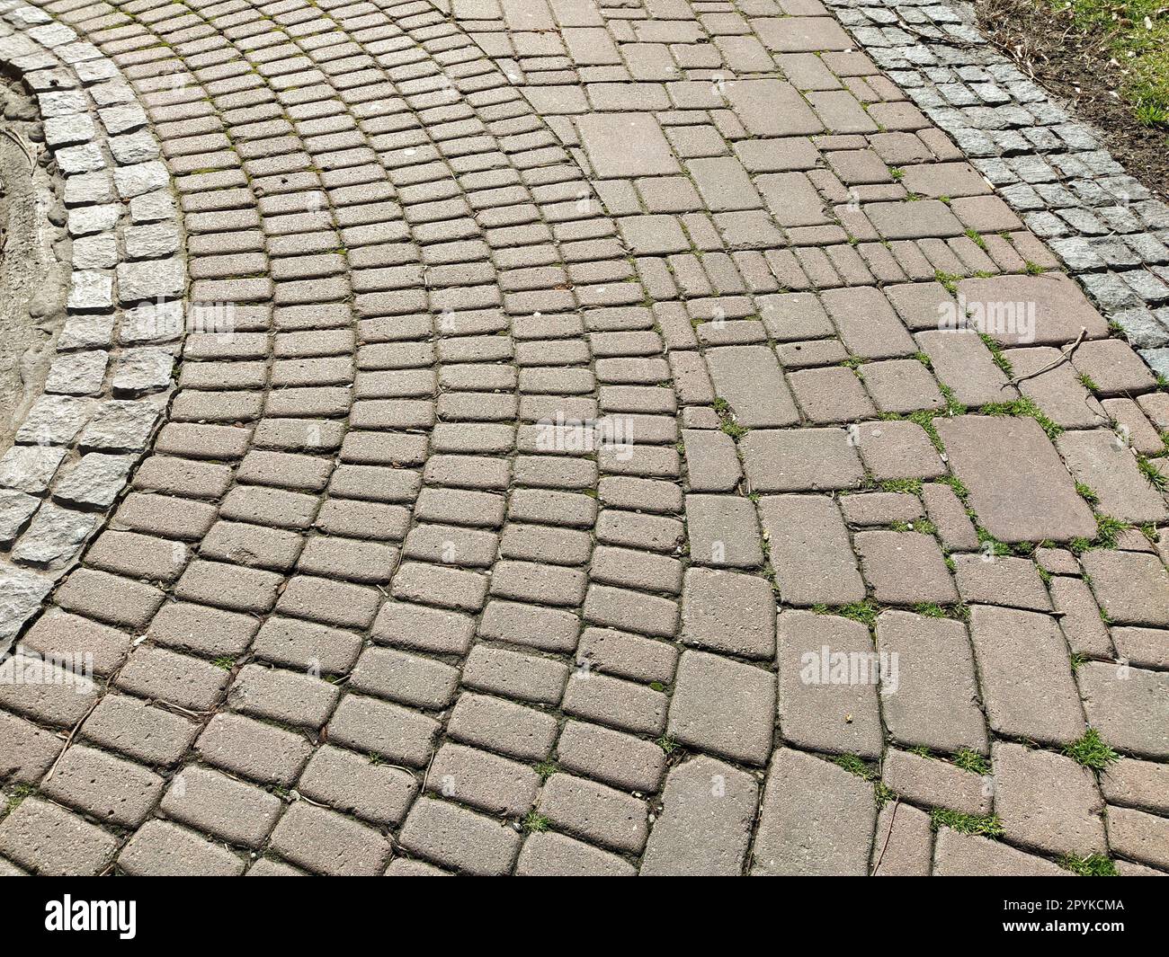 Cobbled street of the old city, lined with square and rectangular stone ...