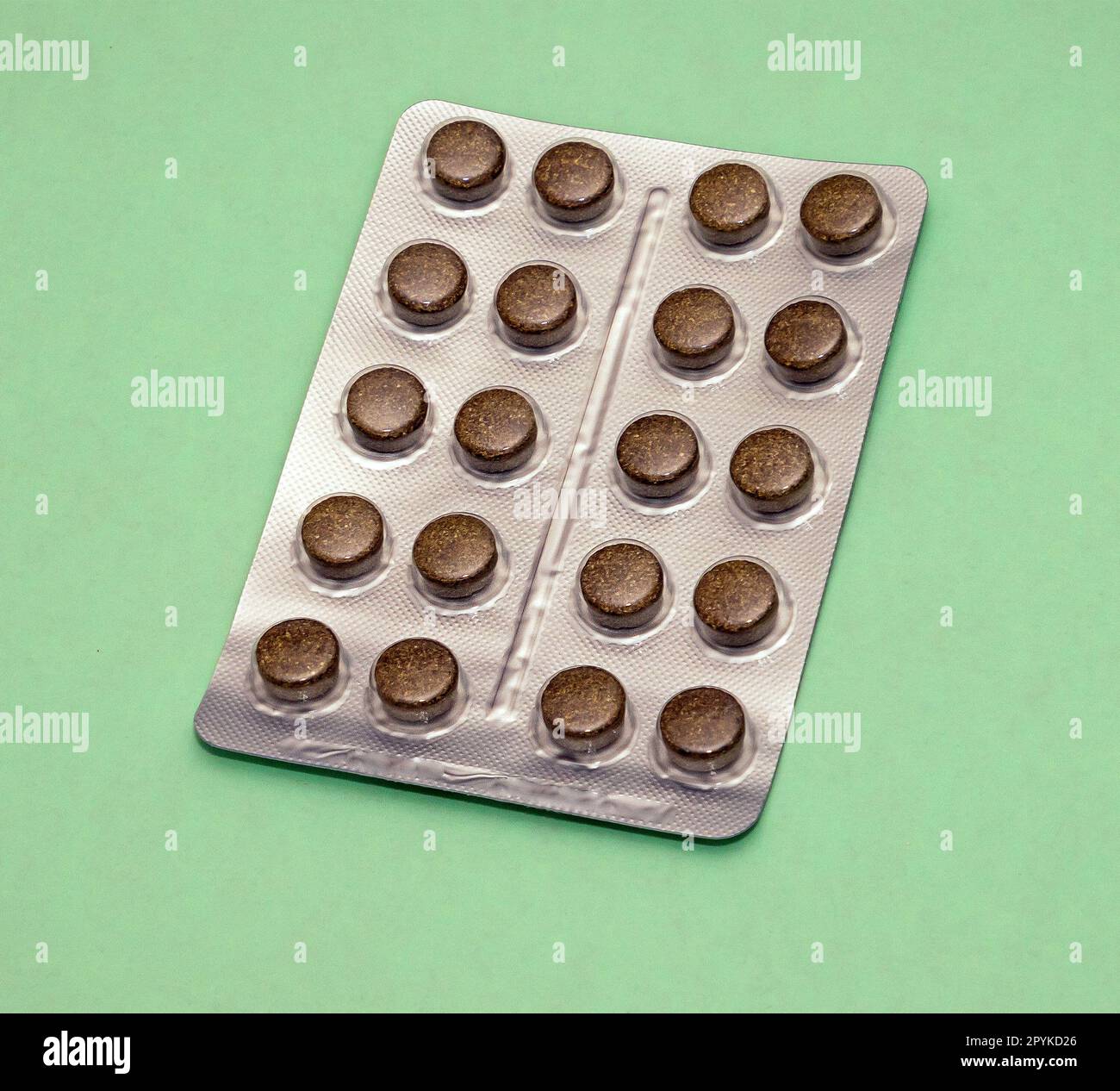 Green pills in blister Stock Photo - Alamy