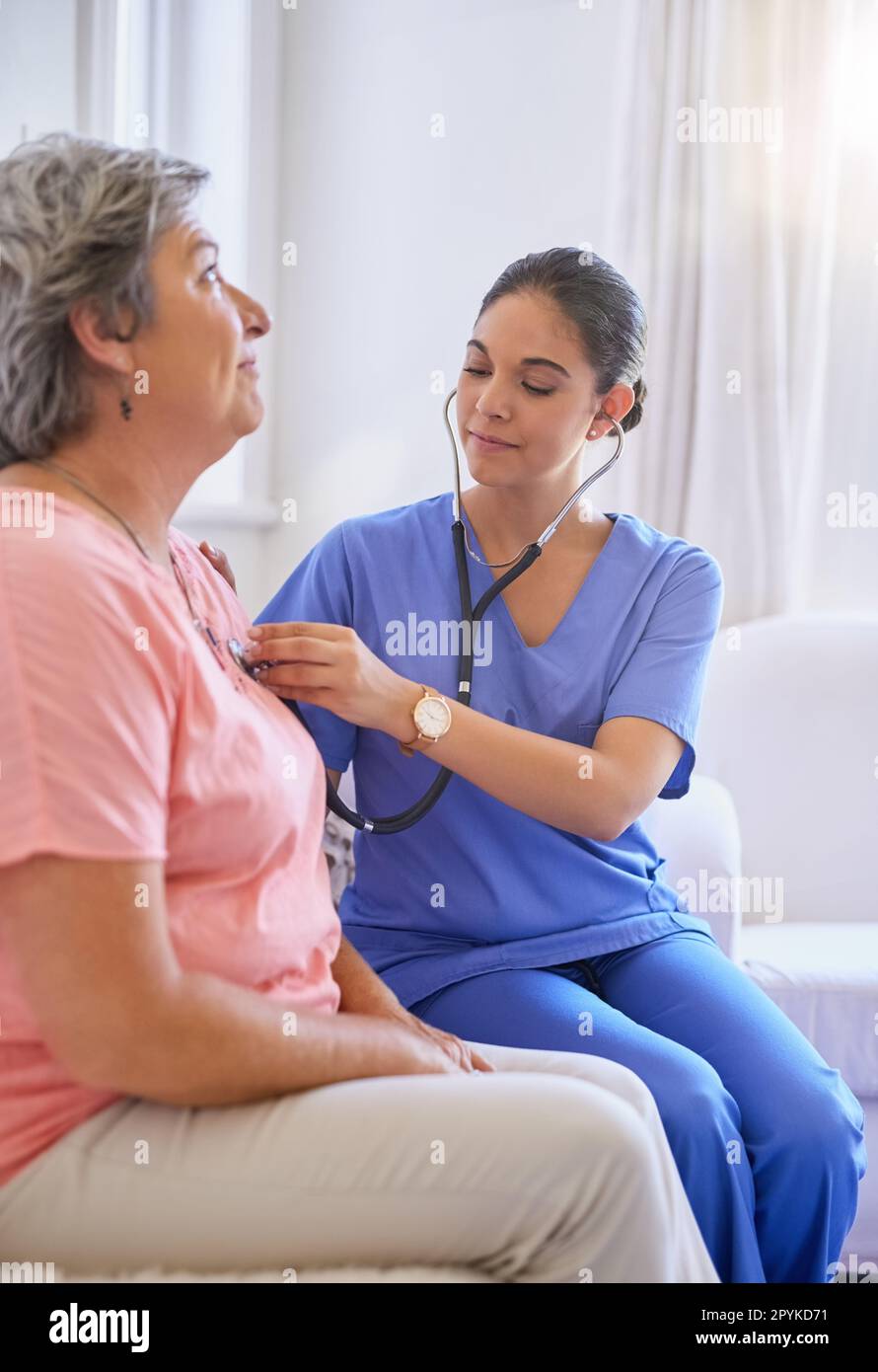 Female nurse examining senior patient hi-res stock photography and ...