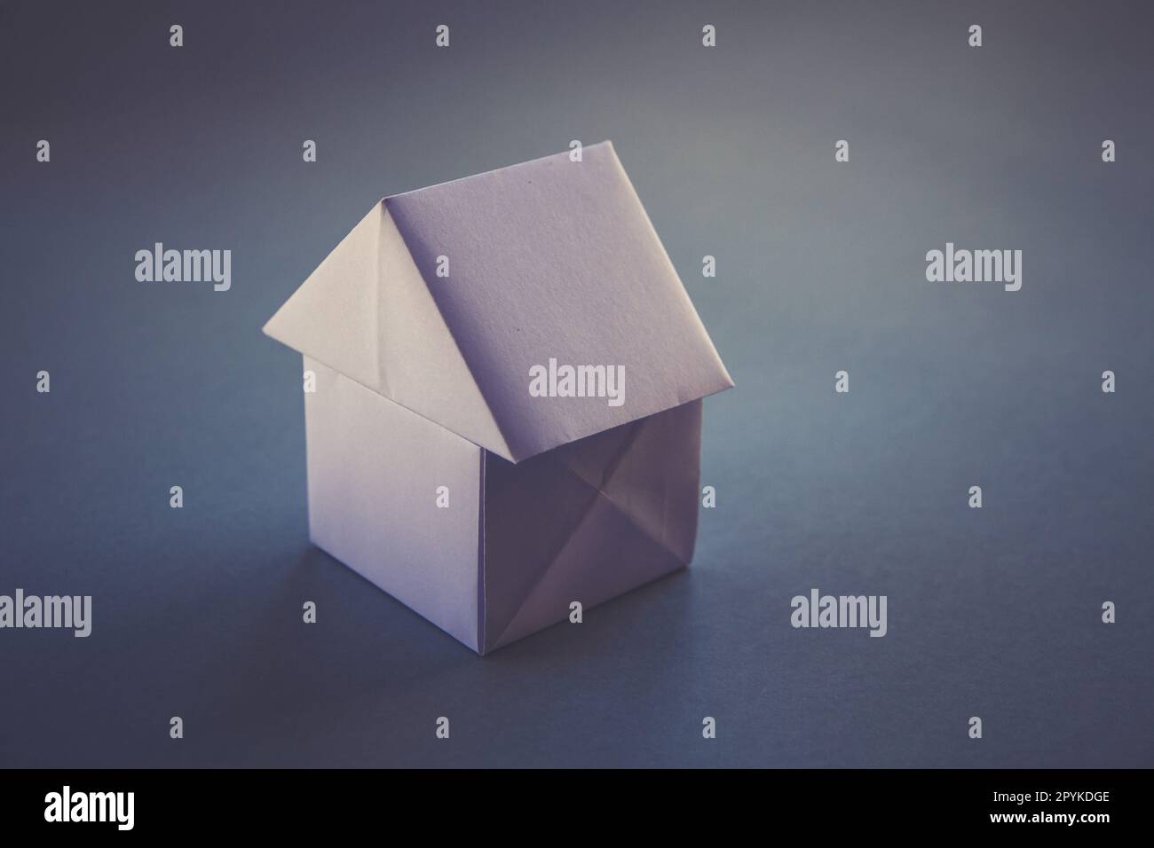 White paper house origami isolated on a blank grey background Stock ...