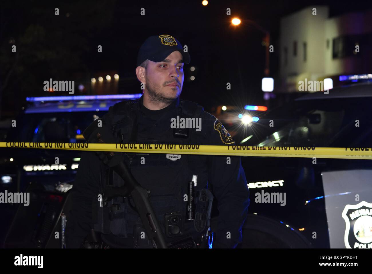 Police officer from Newark police secures the crime scene with a long ...