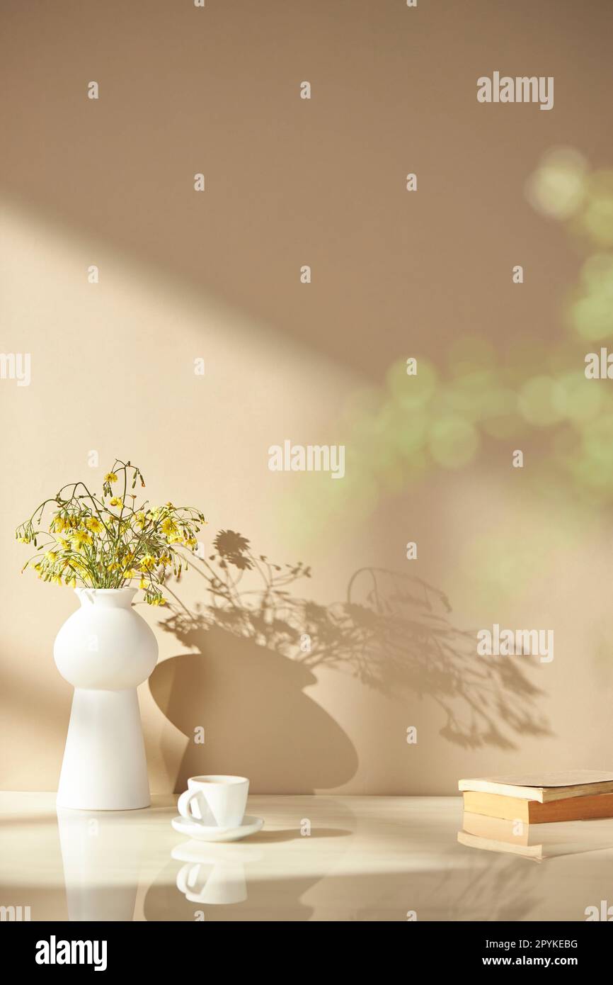 Vases and objects on the table in a warm room with sunlight coming in ...