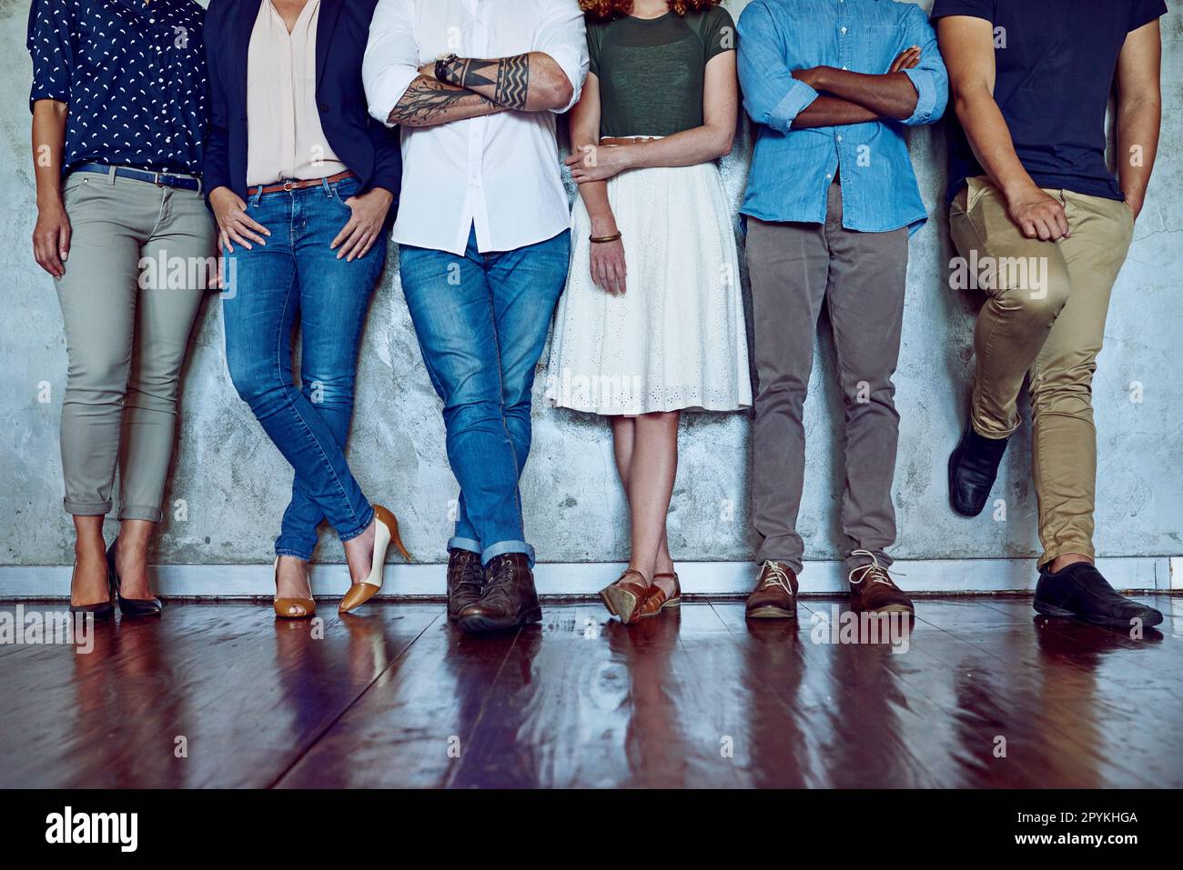 All lined up and ready for success. an unrecognizable group of businesspeople standing against a ...