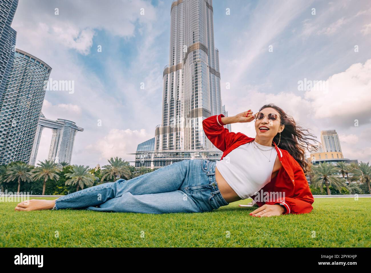 happy student girl lying on a grass and enjoying incredible view of ...
