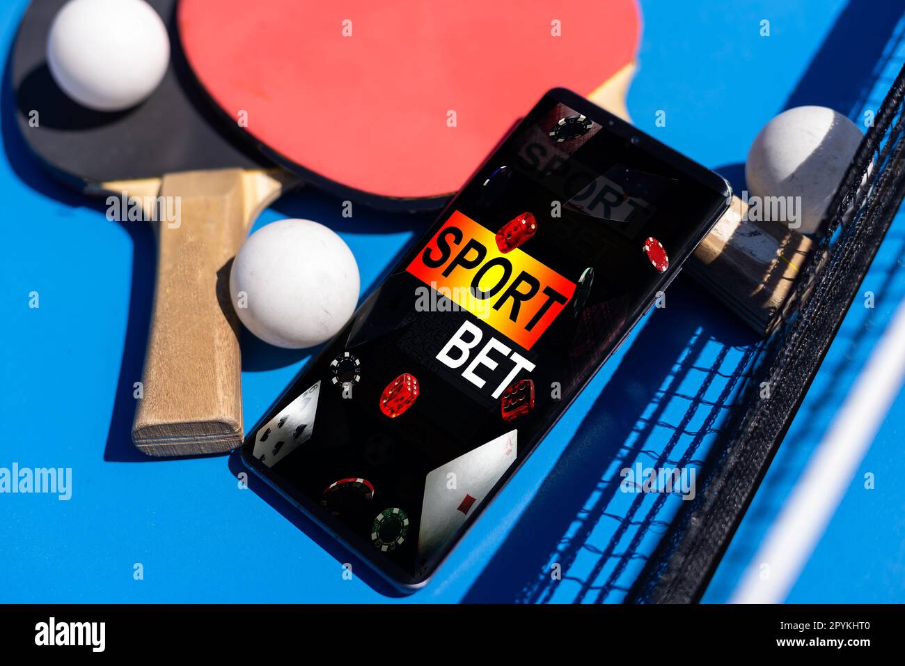 Smartphone on a blue table with ping pong rackets, rope and on ...
